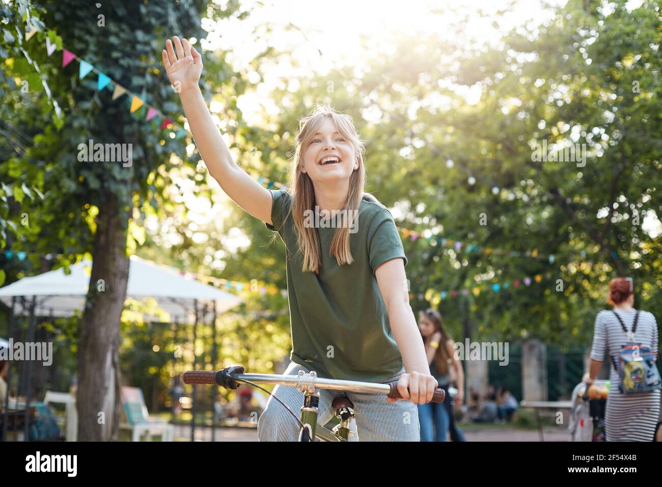 Girl riding bike in park. Portrait of a young female riding a bycicle ...