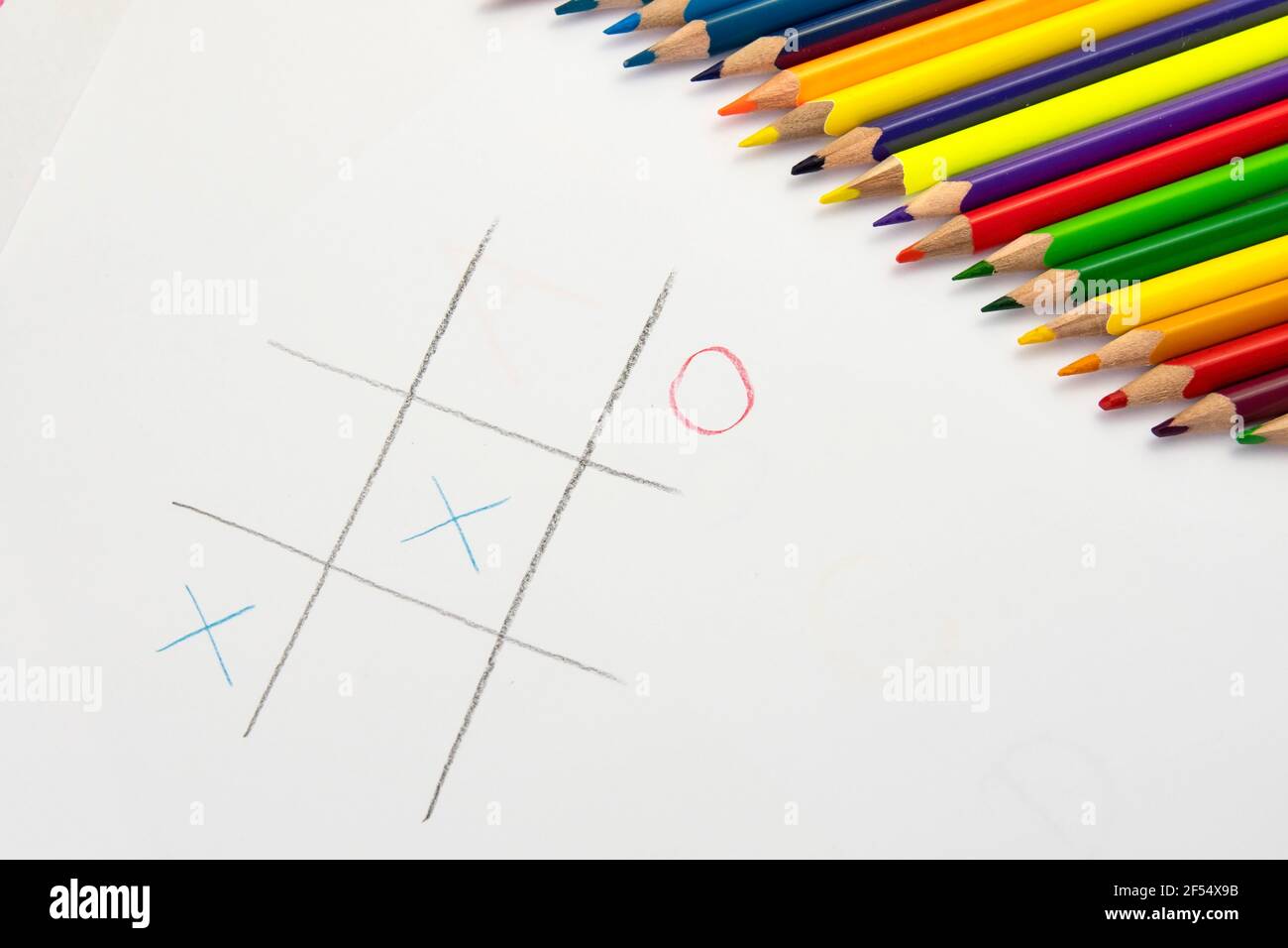 Learning colors and x o game with color pencils on white paper Stock ...