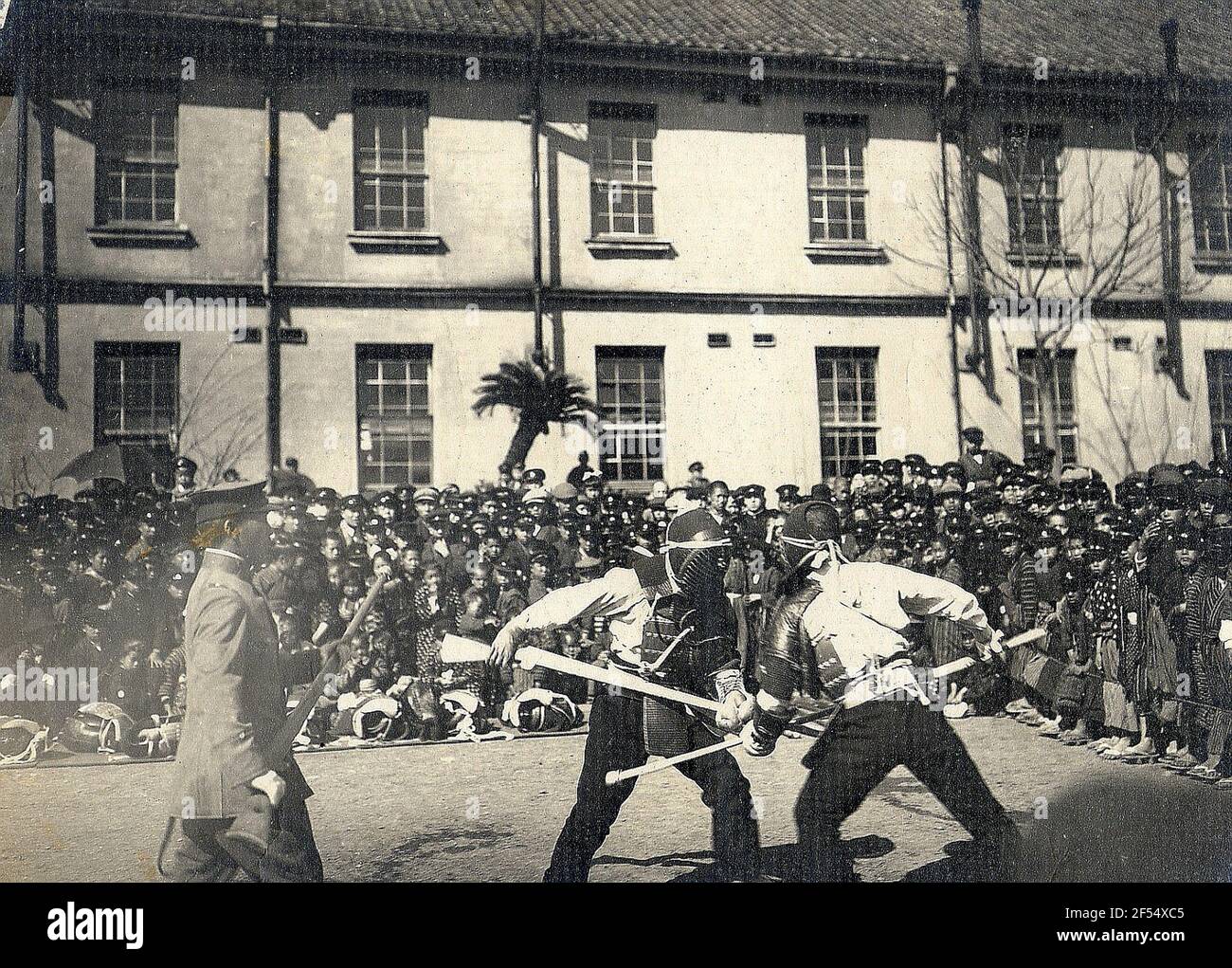 Nagasaki. Two Japanese soldiers in fencing before spectators. View ...