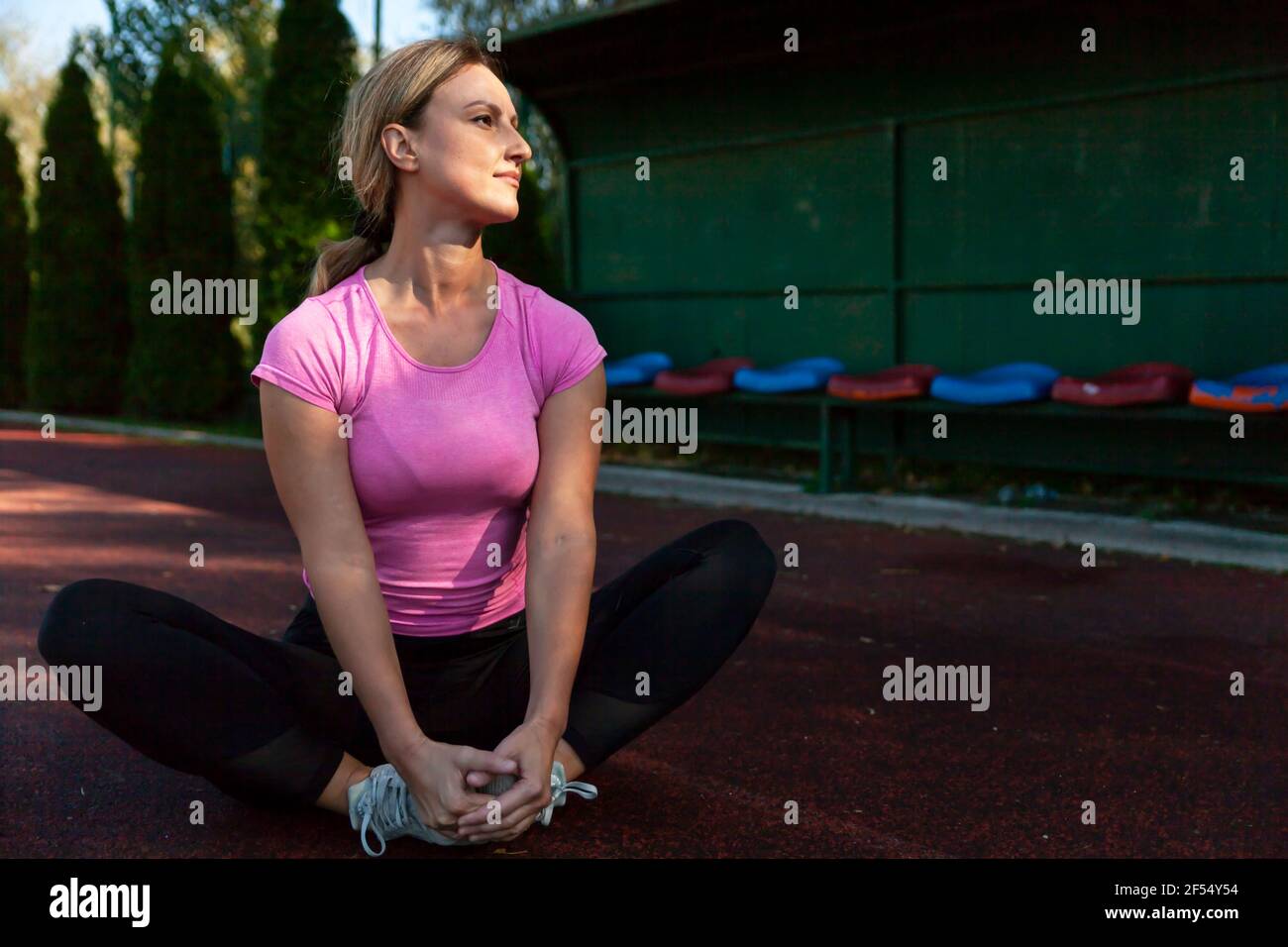 The athlete sits and normalizes her body after a strenuous workout ...