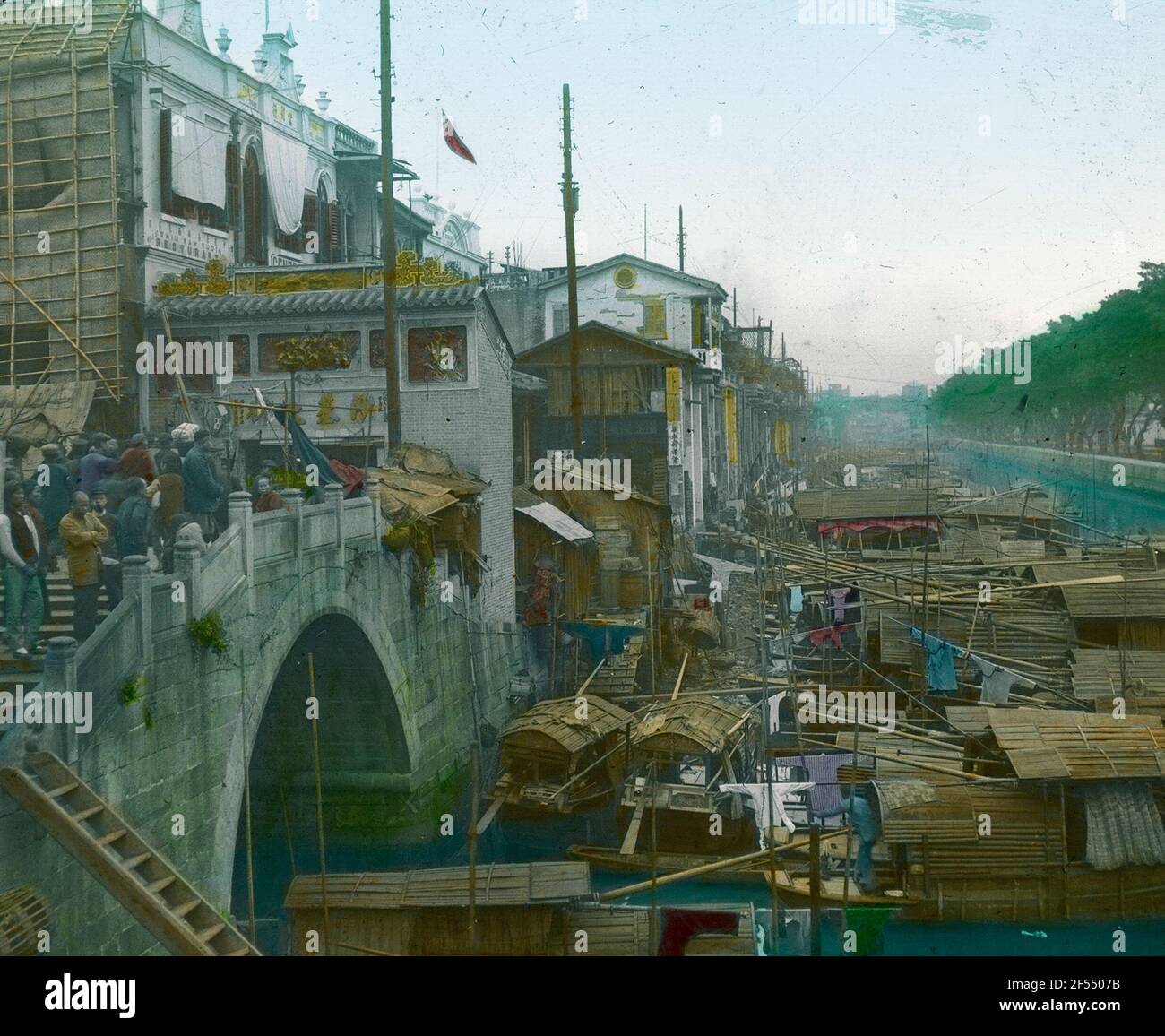 Canton (Guangzhou), China. Urban canal with bridge and various boats ...