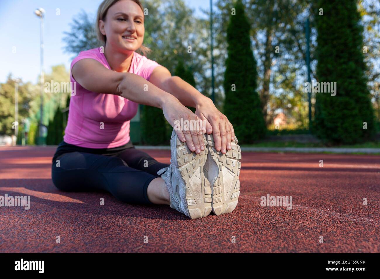 Female athlete stretches her legs hi-res stock photography and images ...