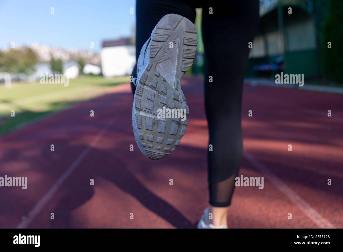 a woman stretches her legs in the stadium Stock Photo - Alamy