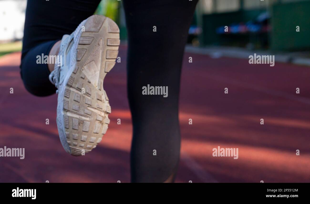 a woman stretches her legs in the stadium Stock Photo - Alamy
