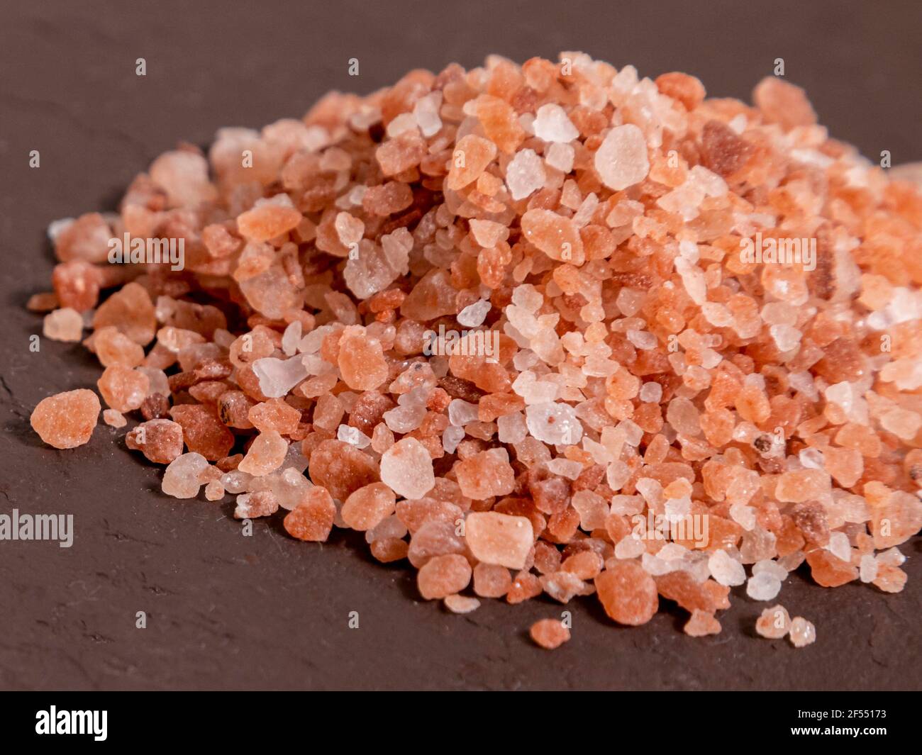 Himalayan pink salt on top of a rock. Selective focus Stock Photo - Alamy