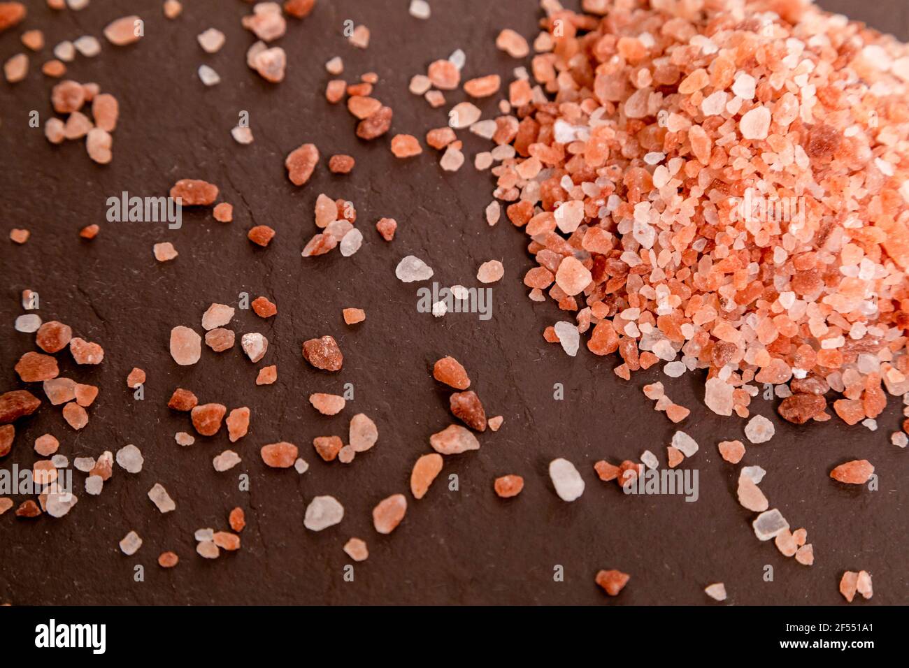 Himalayan pink salt on top of a rock. Selective focus Stock Photo - Alamy