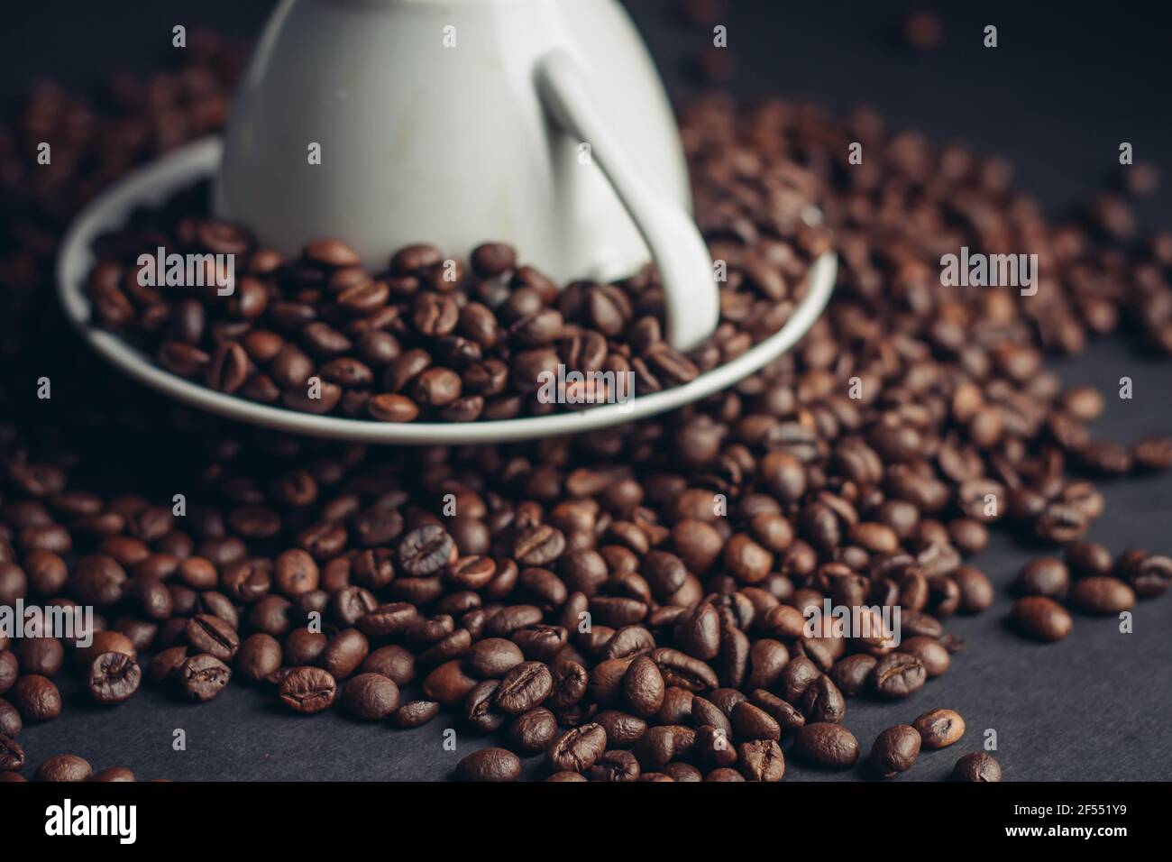 coffee grain on inverted mug and saucer on gray Arabica table Stock ...