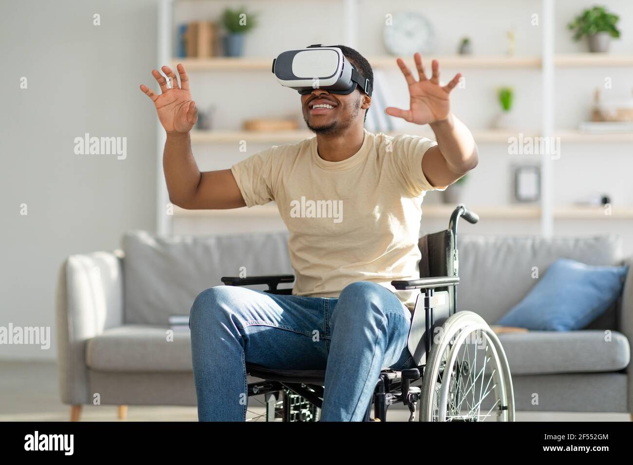 Handicapped black man in wheelchair exploring augmented reality in VR ...