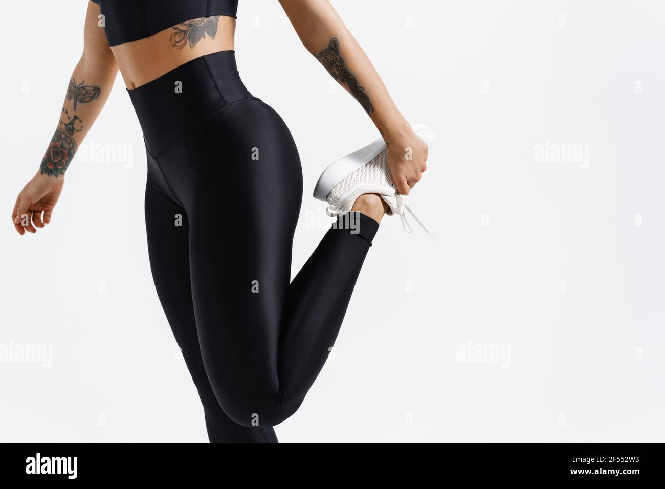 Cropped shot of fitness woman runner stretching legs, warm up before ...