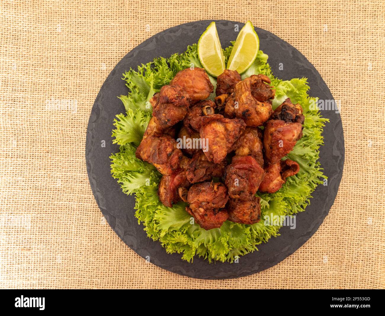 Portion of fried chicken on black stone plate Stock Photo - Alamy