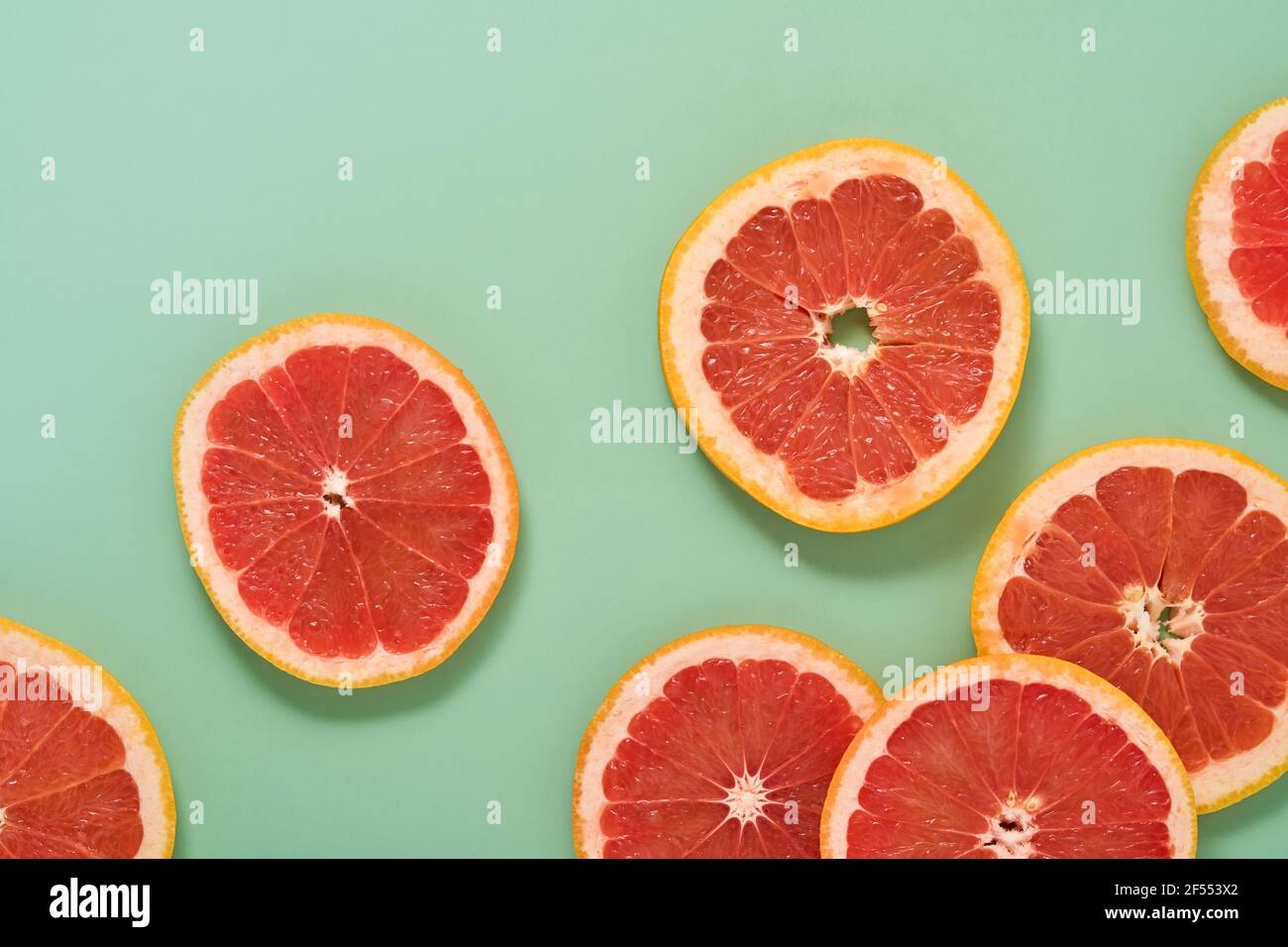 Grapefruit citrus pattern composition. Grapefruit slices with juice are ...