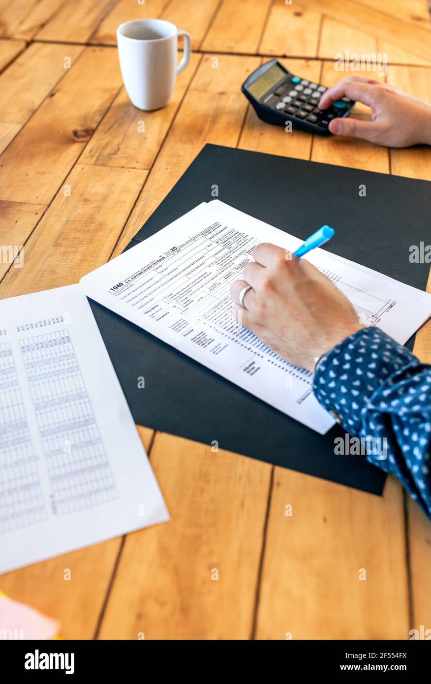 Male taxpayer filling in individual income tax return Stock Photo - Alamy
