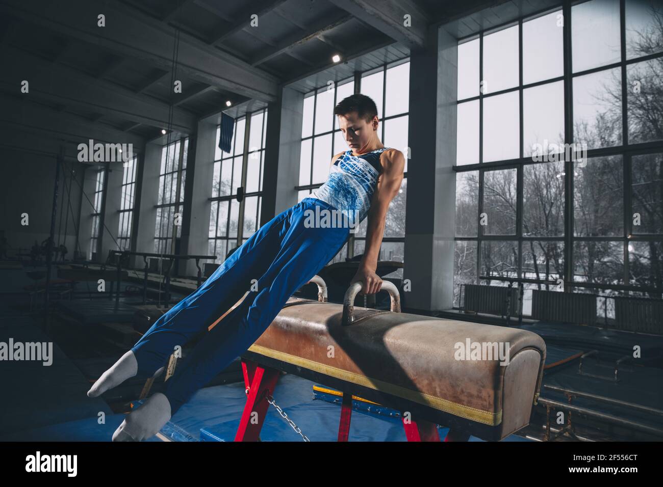 Little male gymnast training in gym, flexible and active. Caucasian fit ...