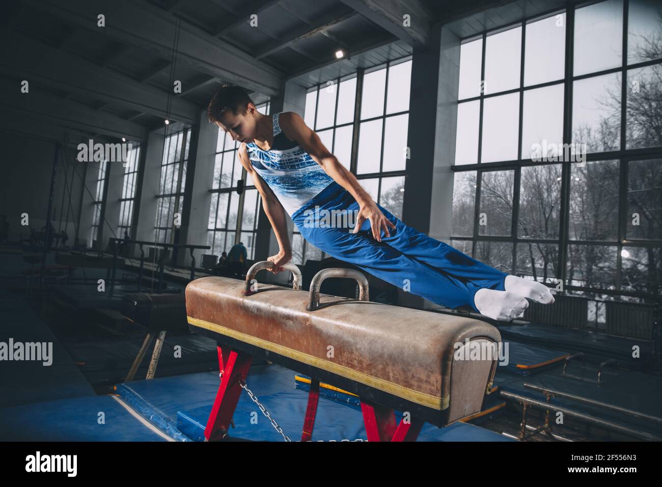 Little male gymnast training in gym, flexible and active. Caucasian fit ...