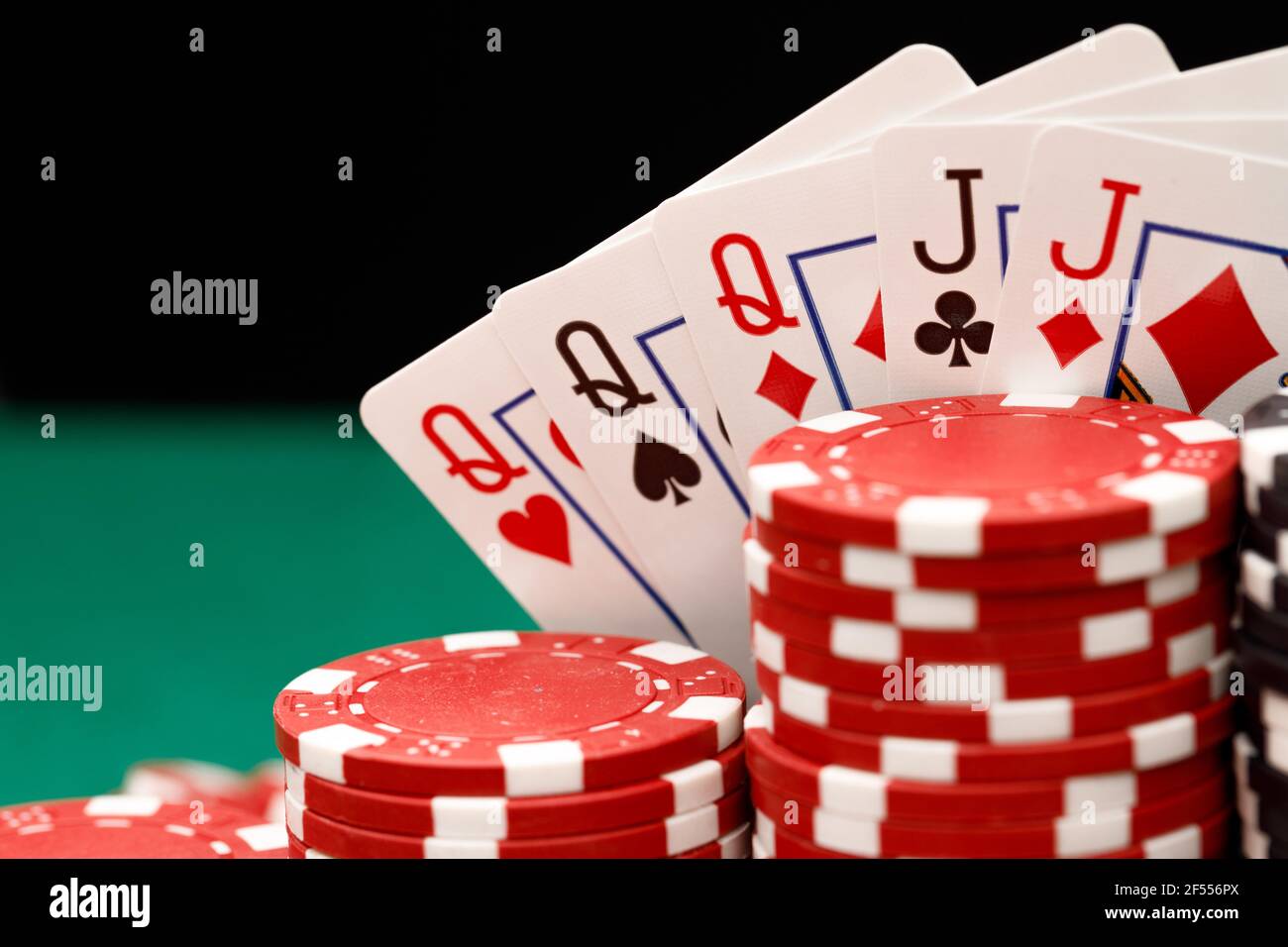 Red playing chips and cards on poker table Stock Photo - Alamy
