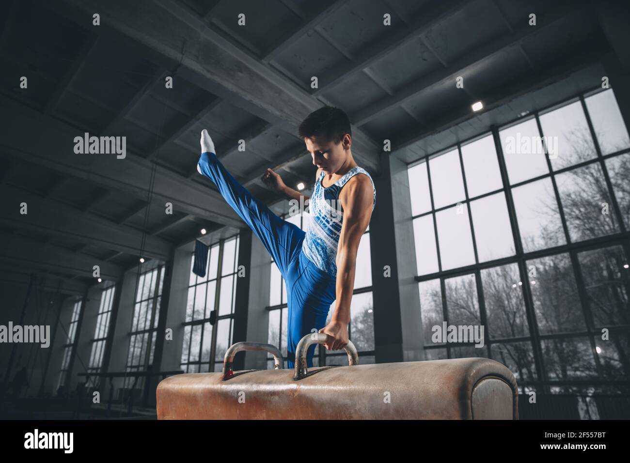 Little male gymnast training in gym, flexible and active. Caucasian fit ...