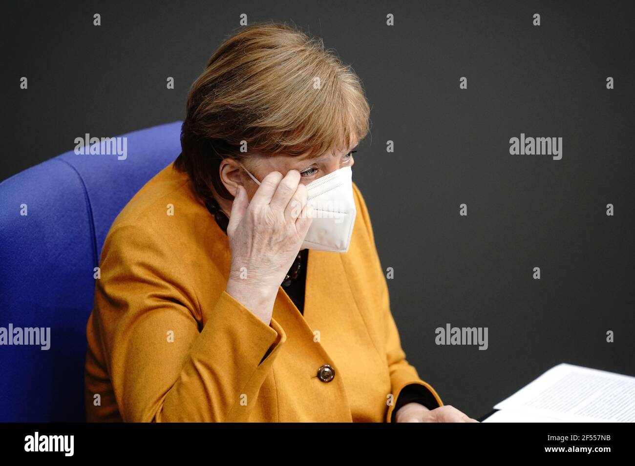 Berlin, Germany. 24th Mar, 2021. Chancellor Angela Merkel (CDU) grabs ...