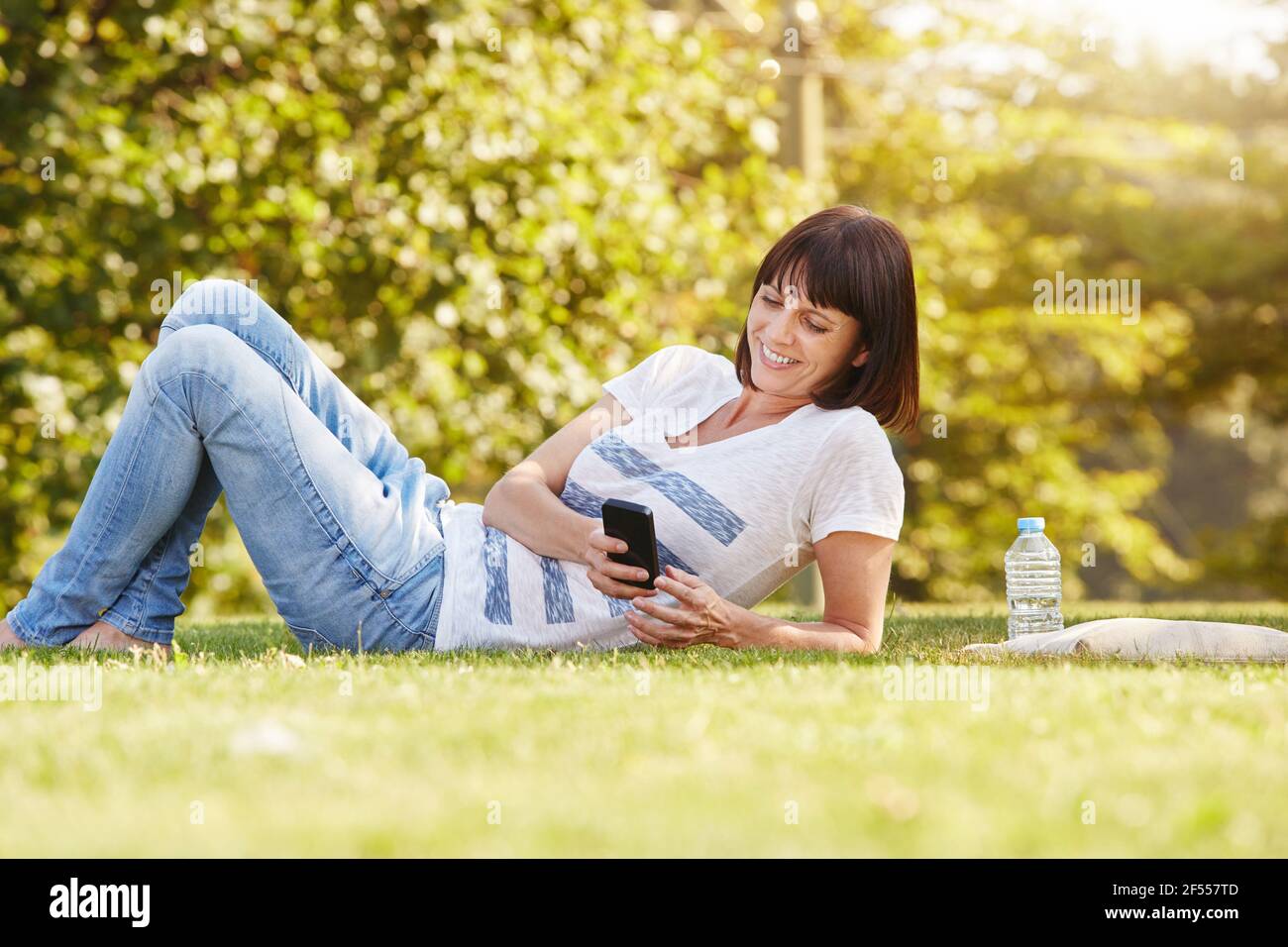 Female body lying in grass hi-res stock photography and images - Alamy