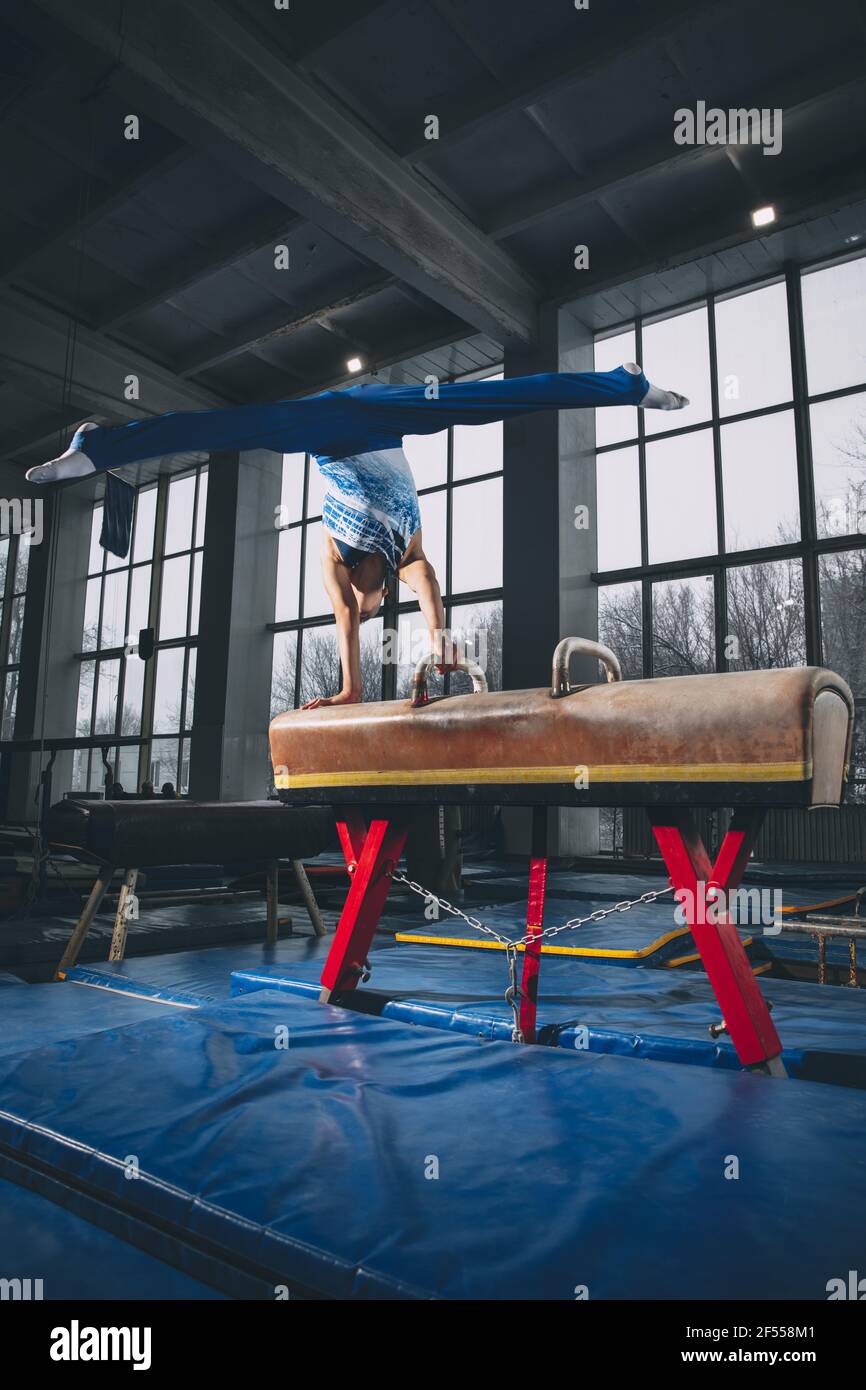 Little male gymnast training in gym, flexible and active. Caucasian fit ...