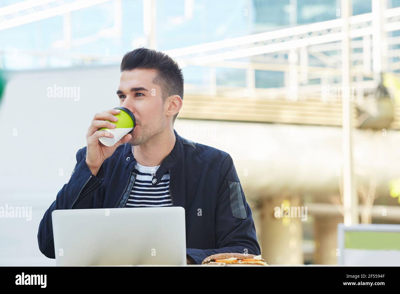 Close up side portrait of handsome man working at outdoor cafe on ...
