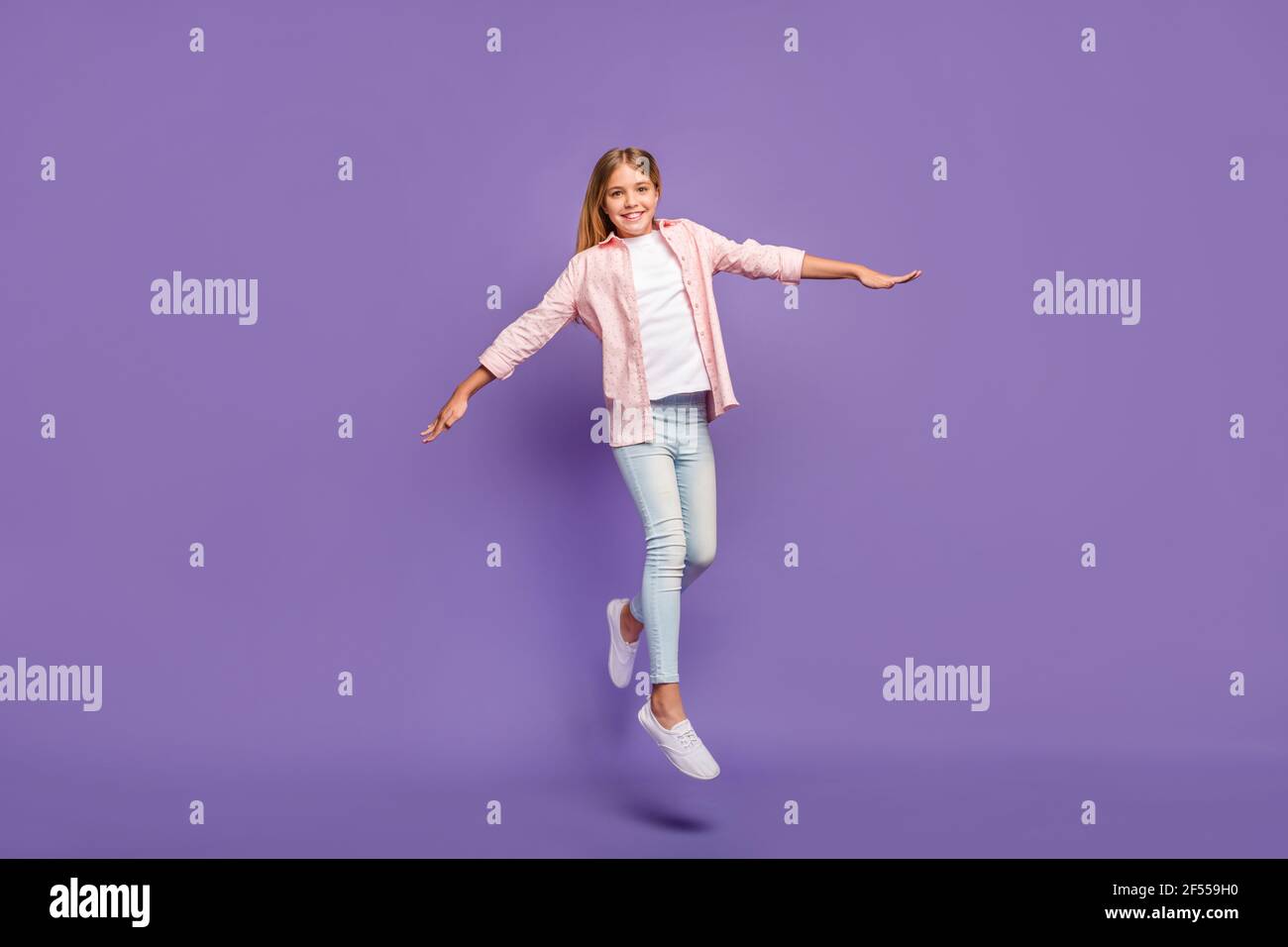 Full size photo of optimistic pretty girl jump show plain wear pink ...