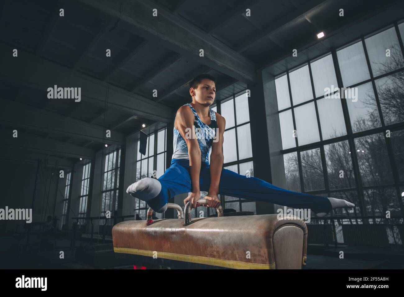 Little male gymnast training in gym, flexible and active. Caucasian fit ...