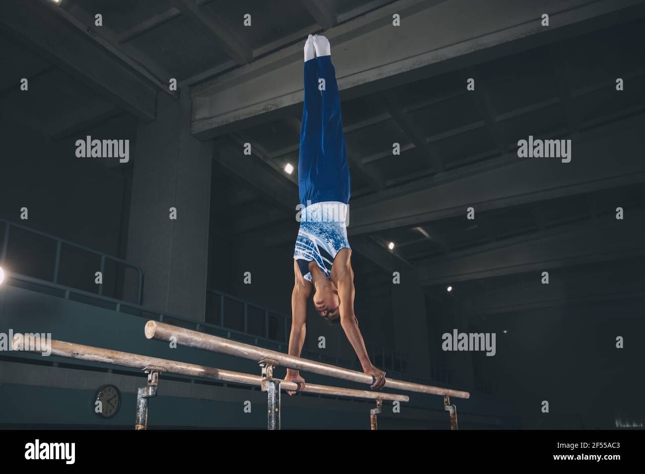 Little male gymnast training in gym, flexible and active. Caucasian fit ...