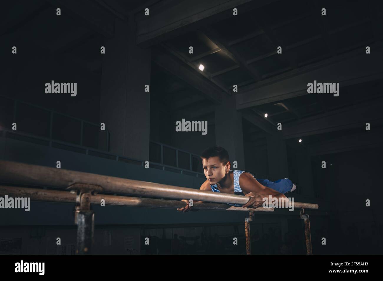 Little male gymnast training in gym, flexible and active. Caucasian fit ...
