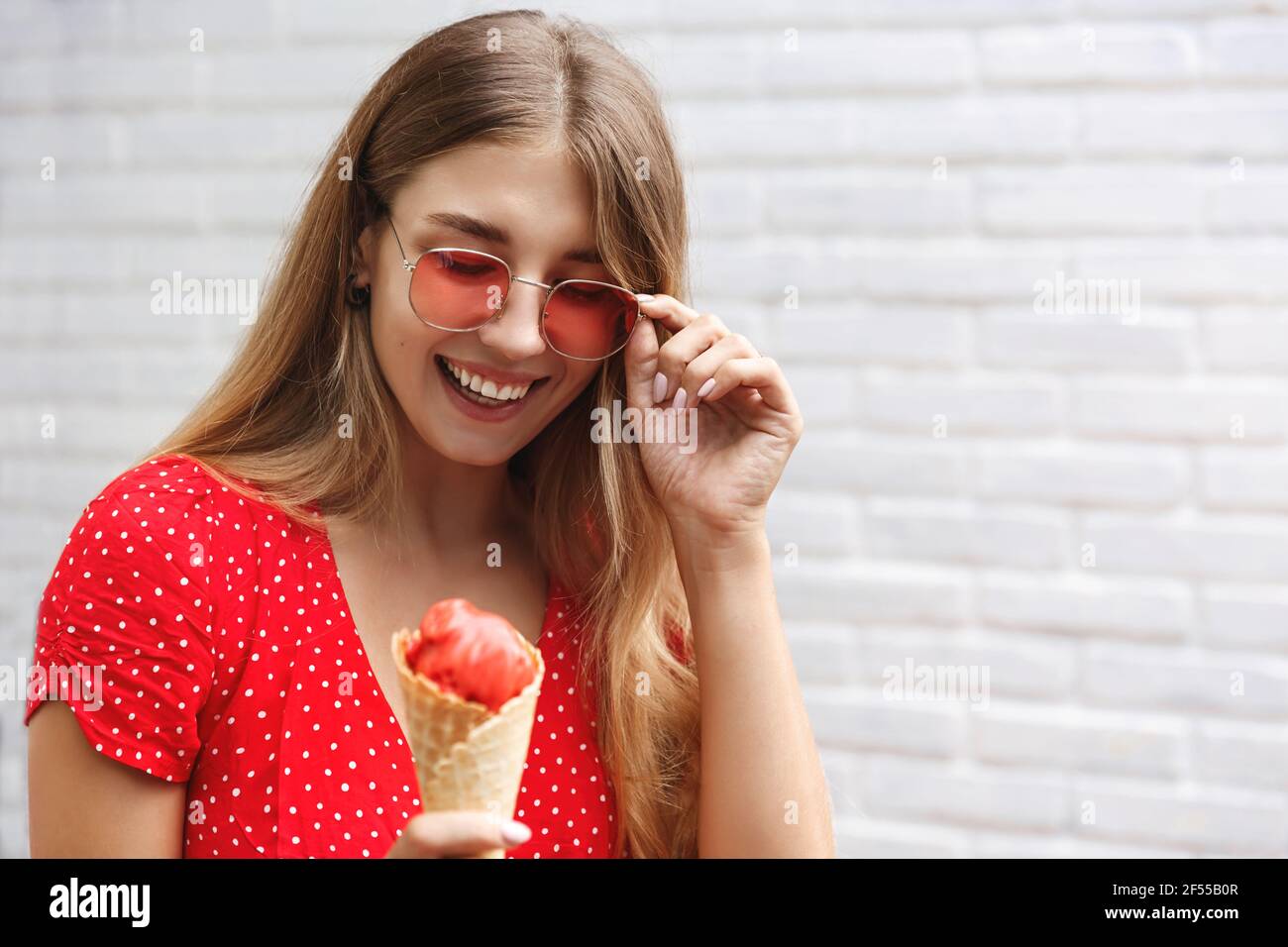 Girl walking eating ice cream on hi-res stock photography and images ...