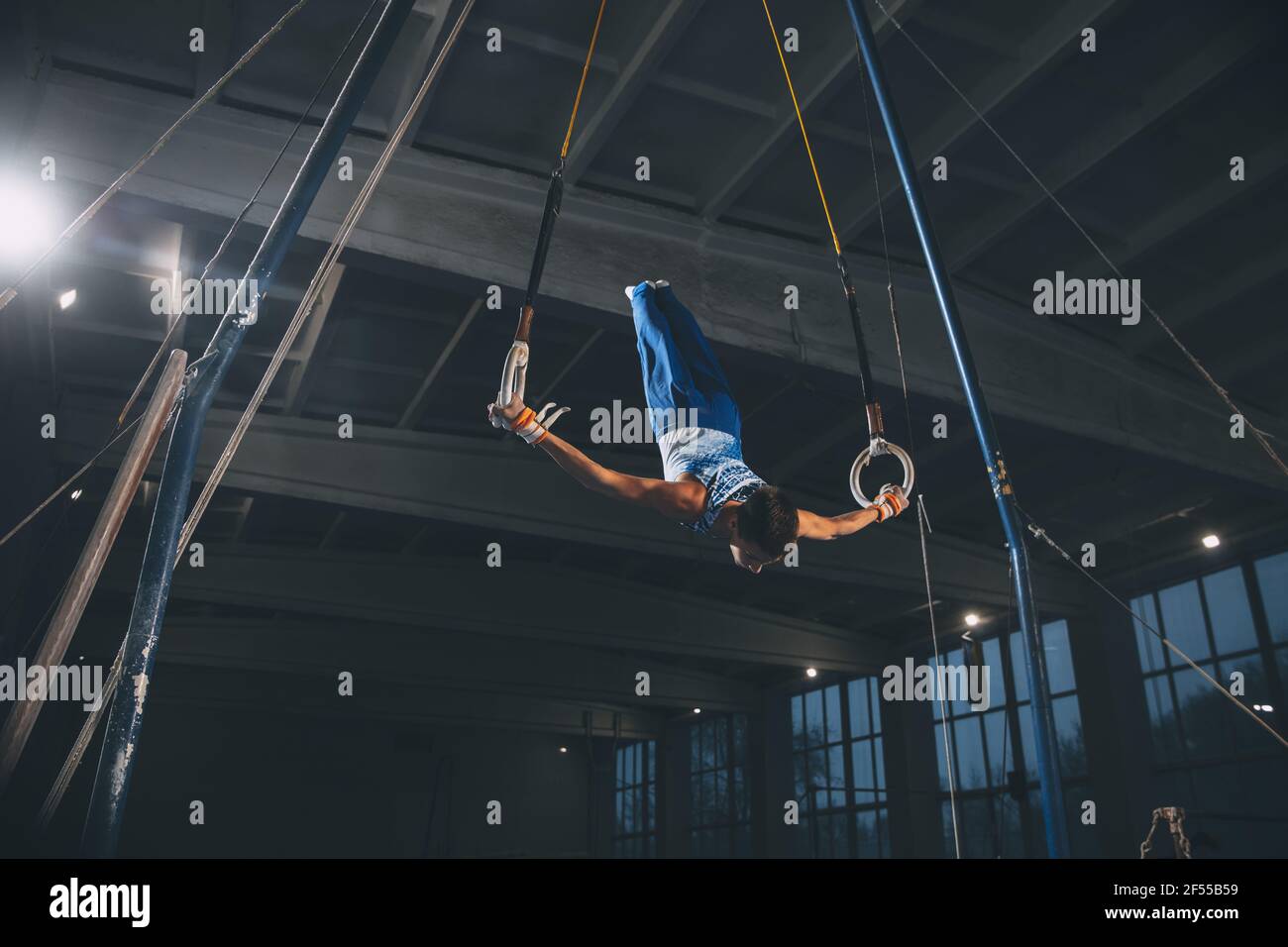 Little male gymnast training in gym, flexible and active. Caucasian fit ...