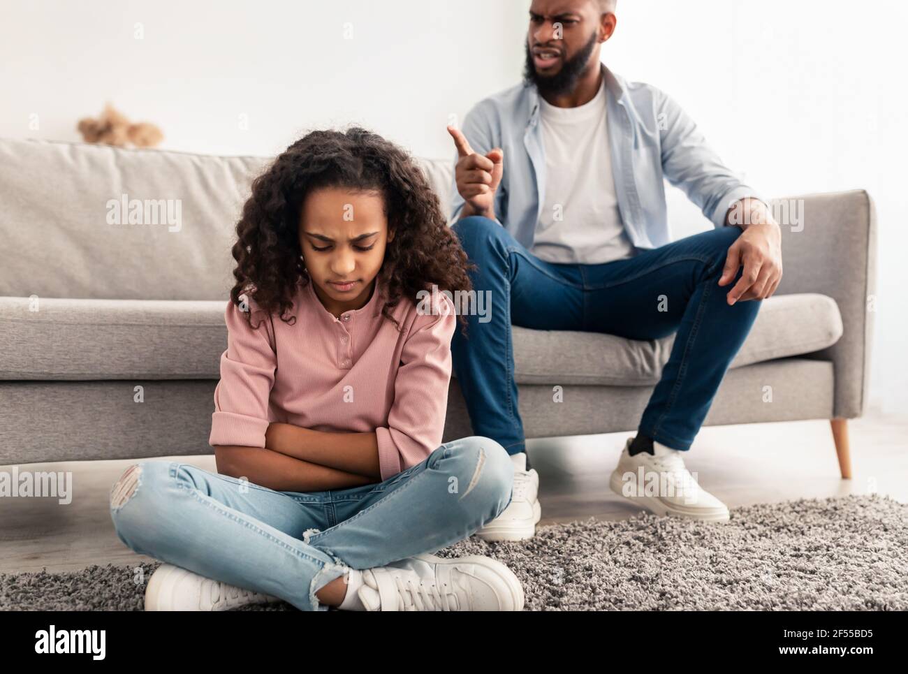 Family Conflict. Angry black father scolding sad daughter Stock Photo ...