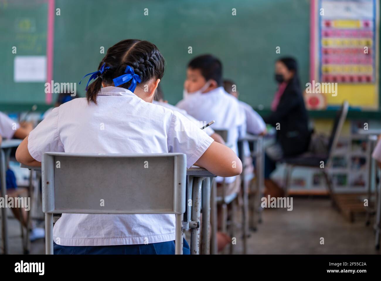 Group of Asian students in uniform studying together at classroom ...