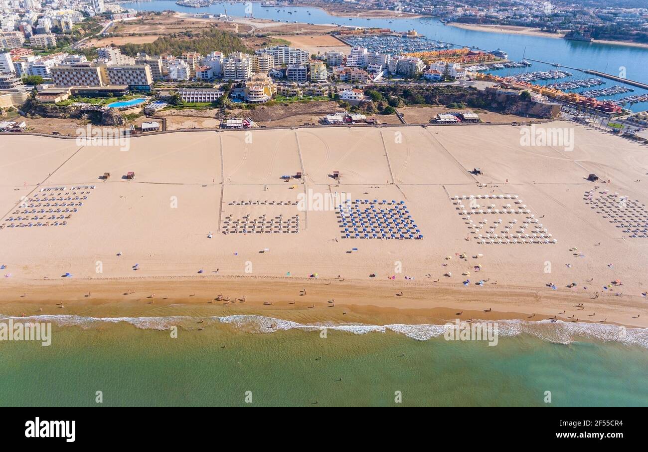 Aerial view, bird's eye view of the Portuguese city of Portimao beaches ...