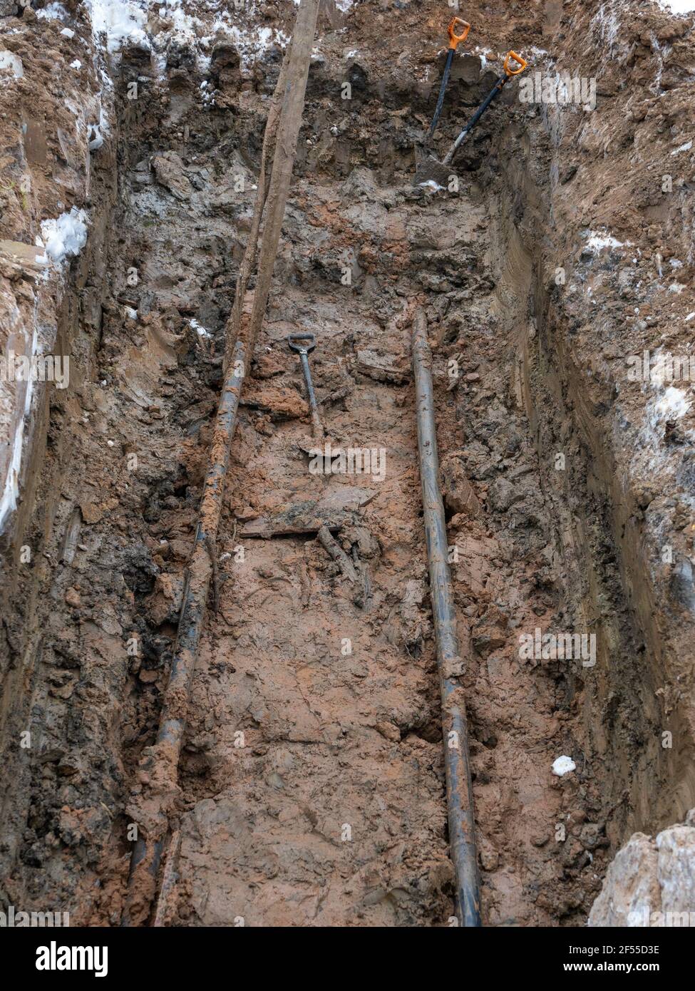 Civil infrastructure pipe, water lines and storm sewers. a pit dug for ...