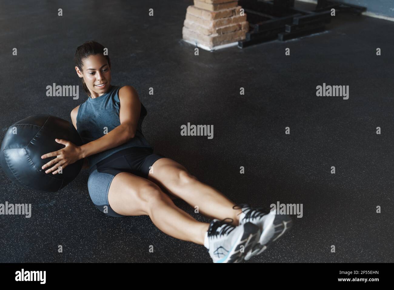 Motivated smiling, gorgeous hispanic woman in activewear, lie on floor ...