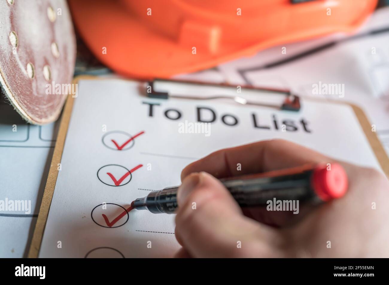 Check off a to do list on a construction site as a symbol for organized ...