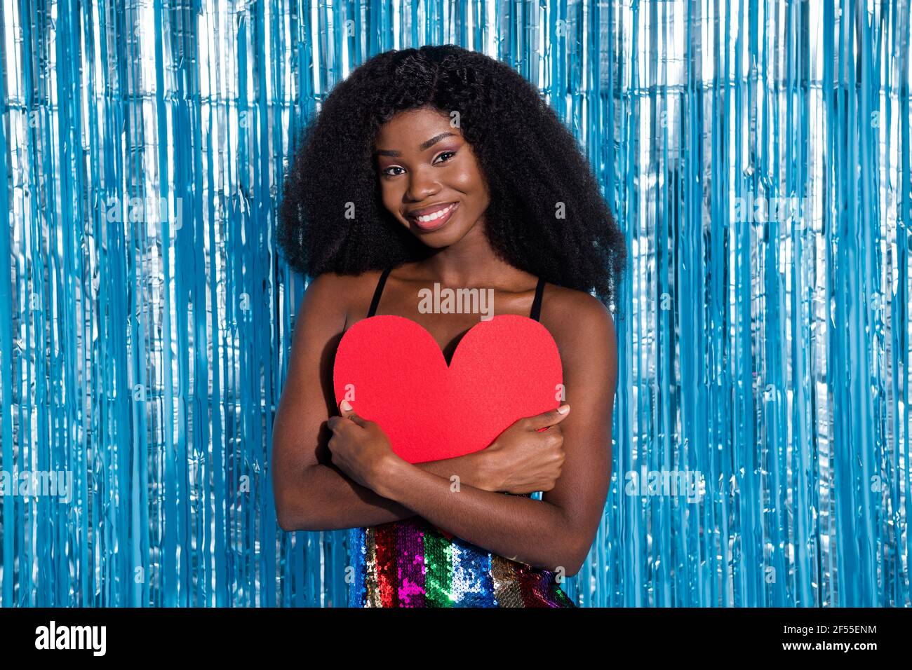 Portrait of attractive cheerful wavy-haired girl holding in hands ...