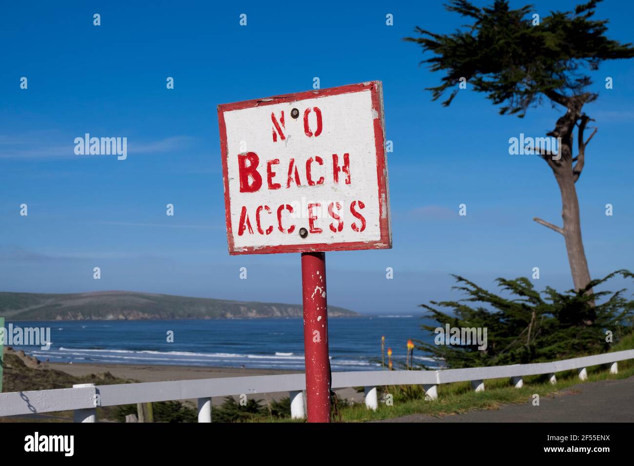 An old, handpainted No Beach Access red and white sign on a pole. At ...