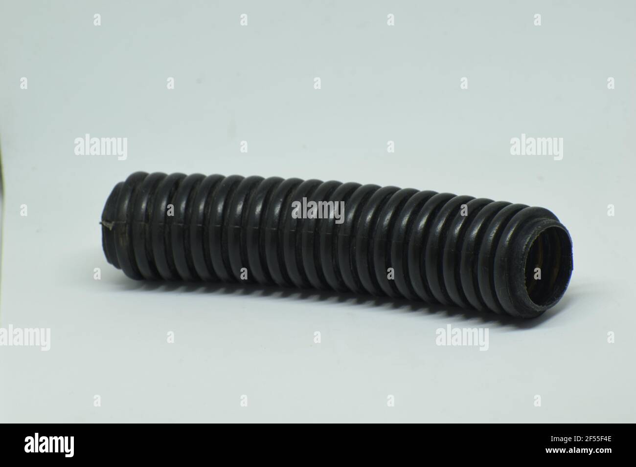 Piece of black corrugated tube on a white background Stock Photo - Alamy