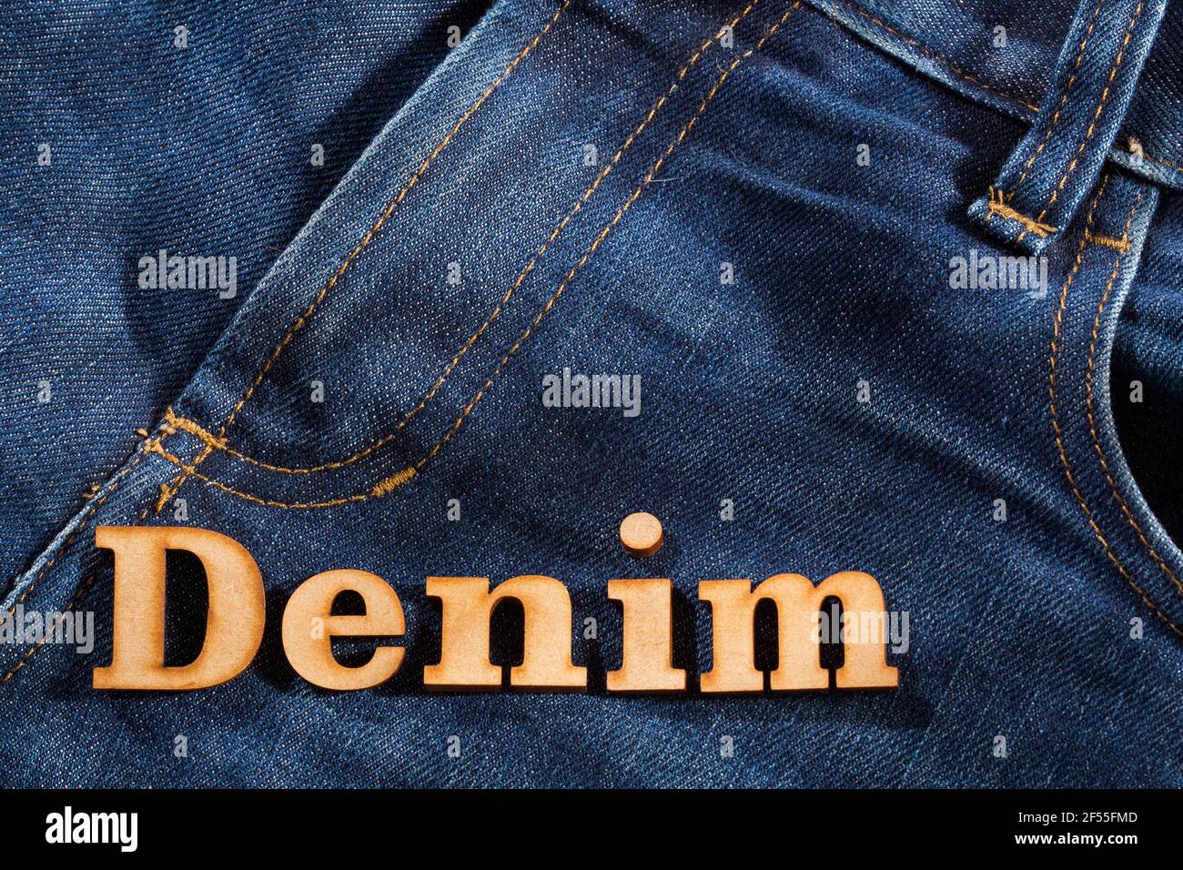Denim in wooden letters with jeans background Stock Photo - Alamy