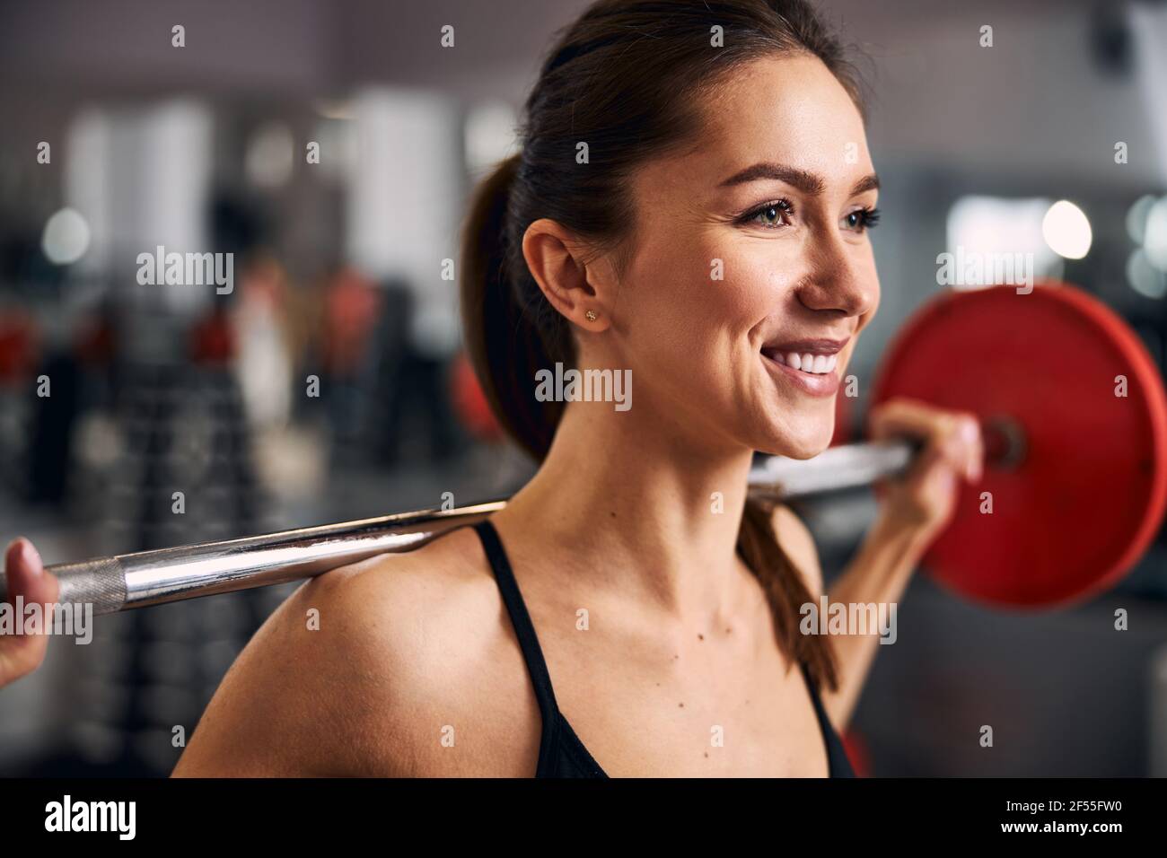 Close up of cute sportswoman lifting barbell Stock Photo - Alamy