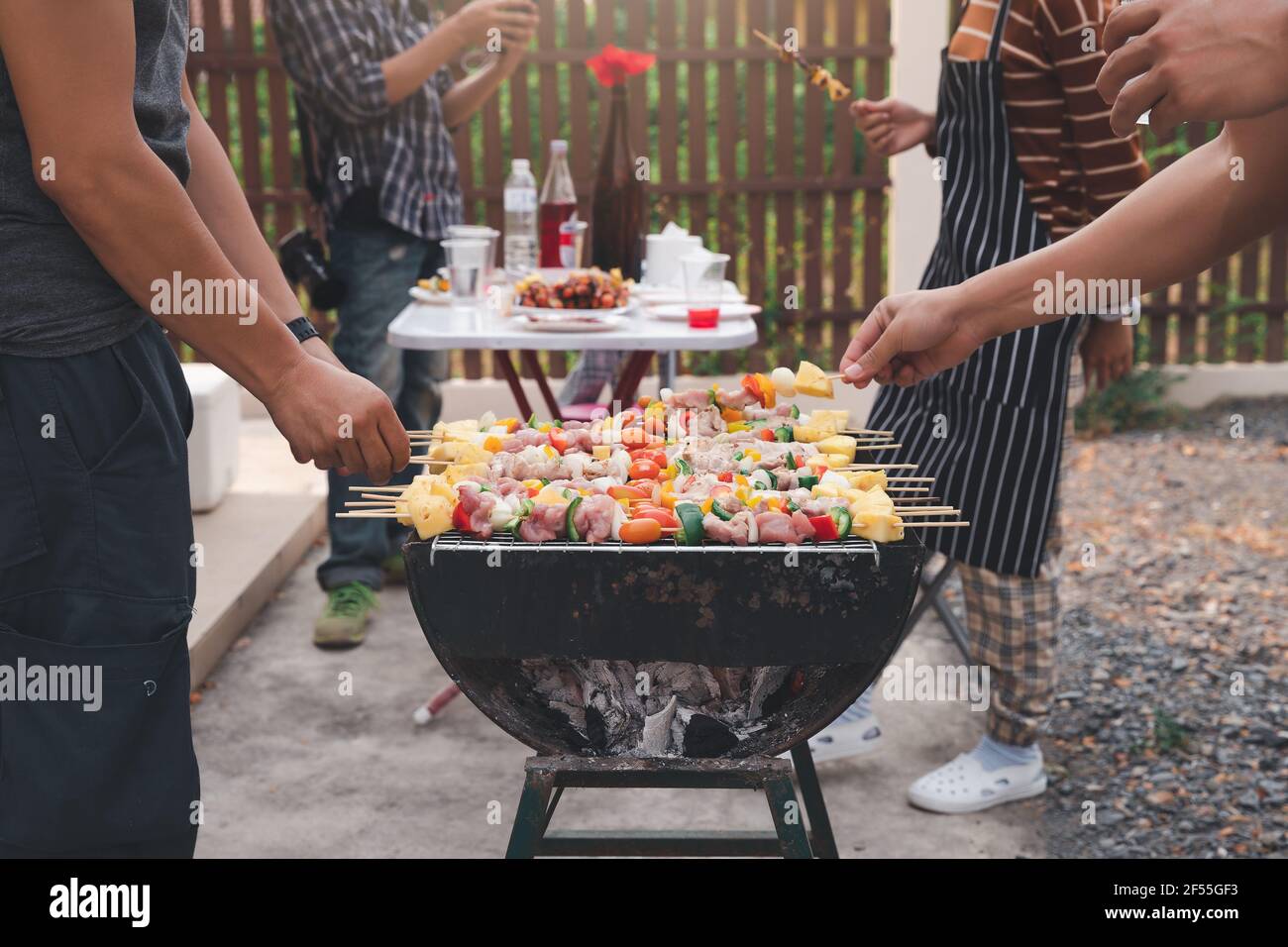 Men grilling pork and barbecue in dinner party. Food, people and family ...