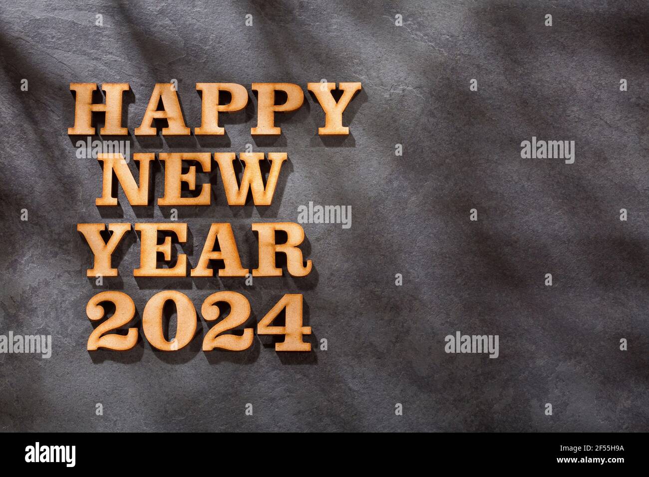 Happy new year 2024 in wooden letters - Text space Stock Photo - Alamy