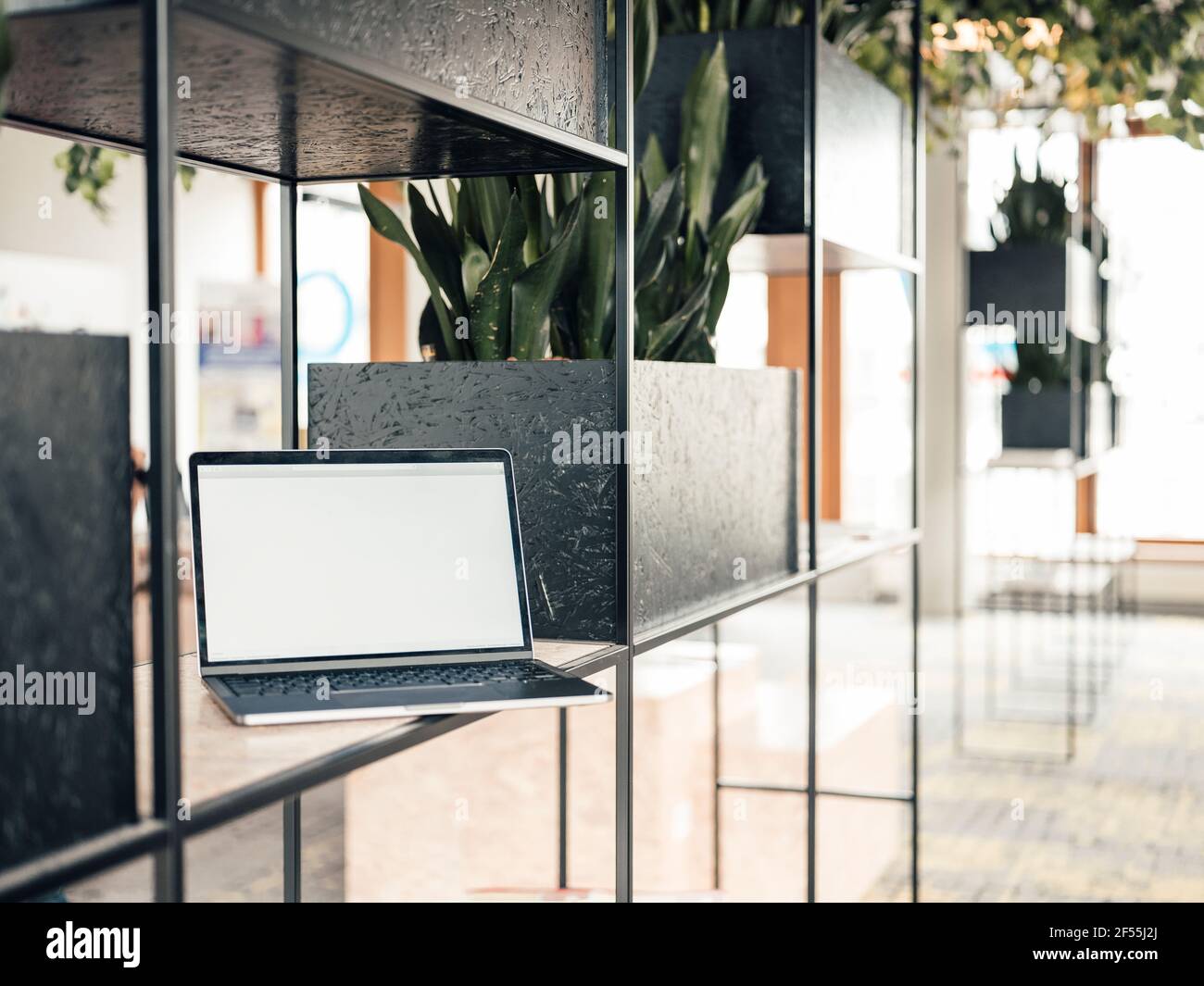 Laptop on rack in office Stock Photo - Alamy