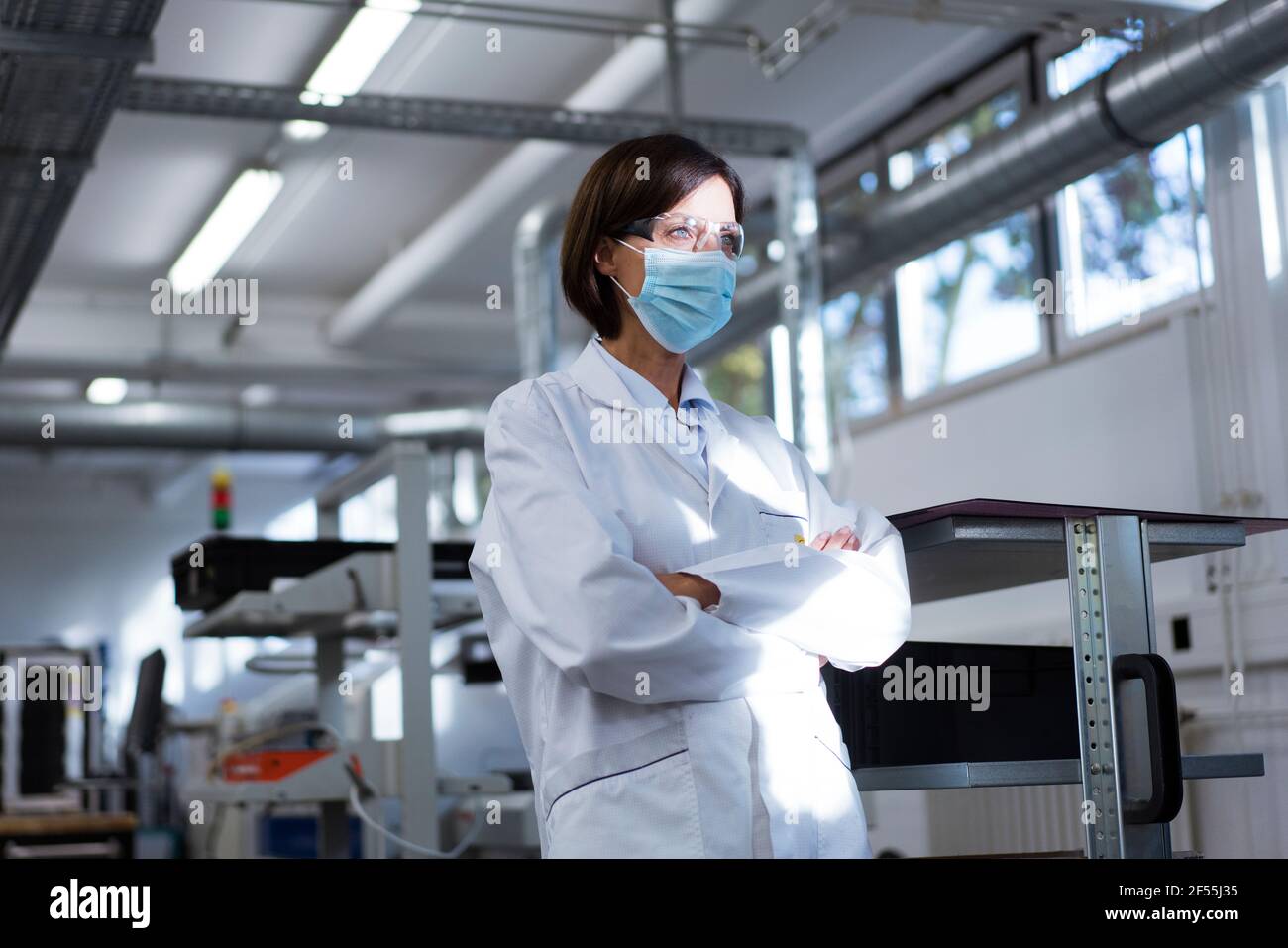 Female scientist with arms crossed in laboratory during pandemic Stock Photo - Alamy
