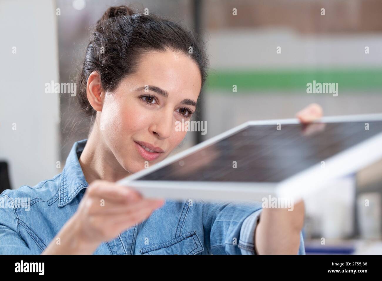 Female entrepreneur analyzing solar panel model at office Stock Photo ...