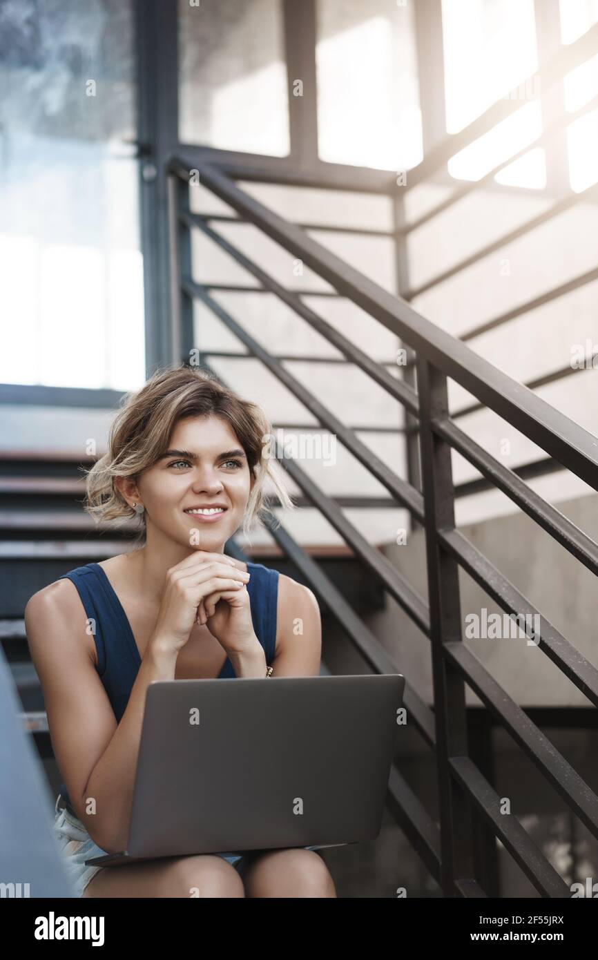 Vertical shot dreamy ambitious good-looking blond young girl student ...