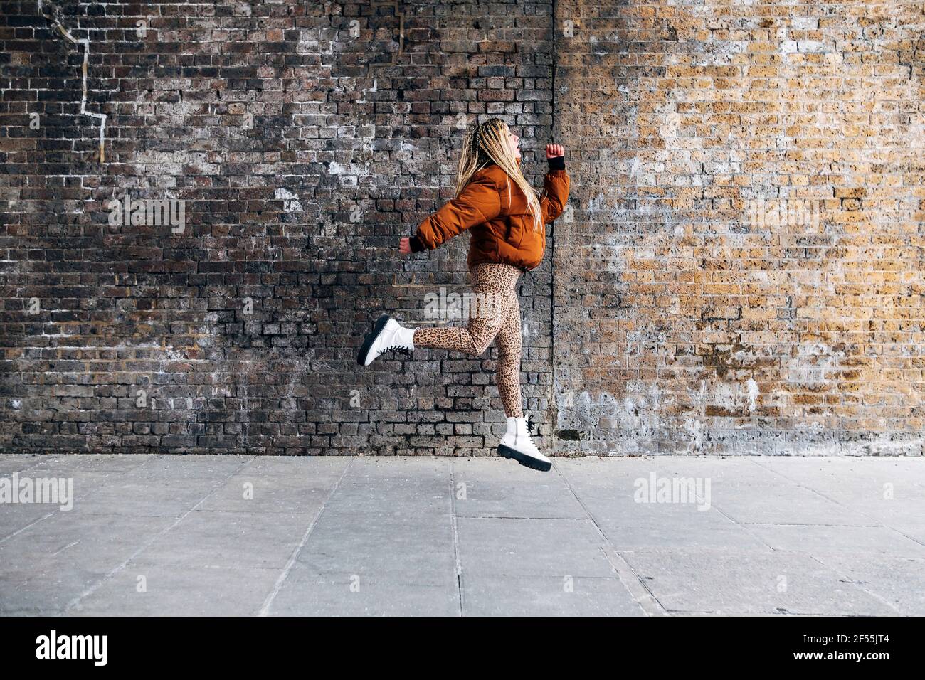 Young woman jumping concrete wall hi-res stock photography and images ...
