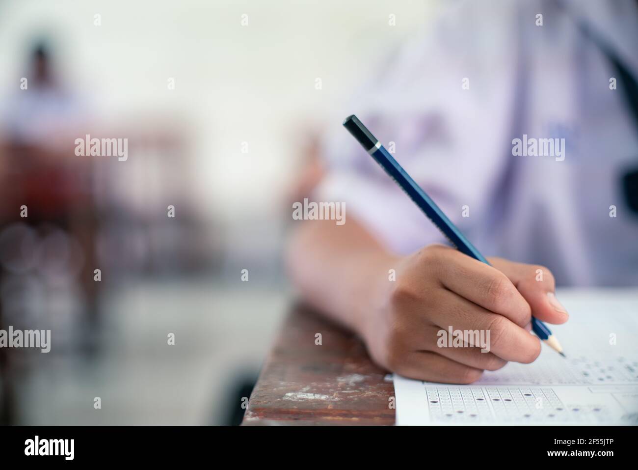 Student writing pen in hand doing exams answer sheets exercises in ...