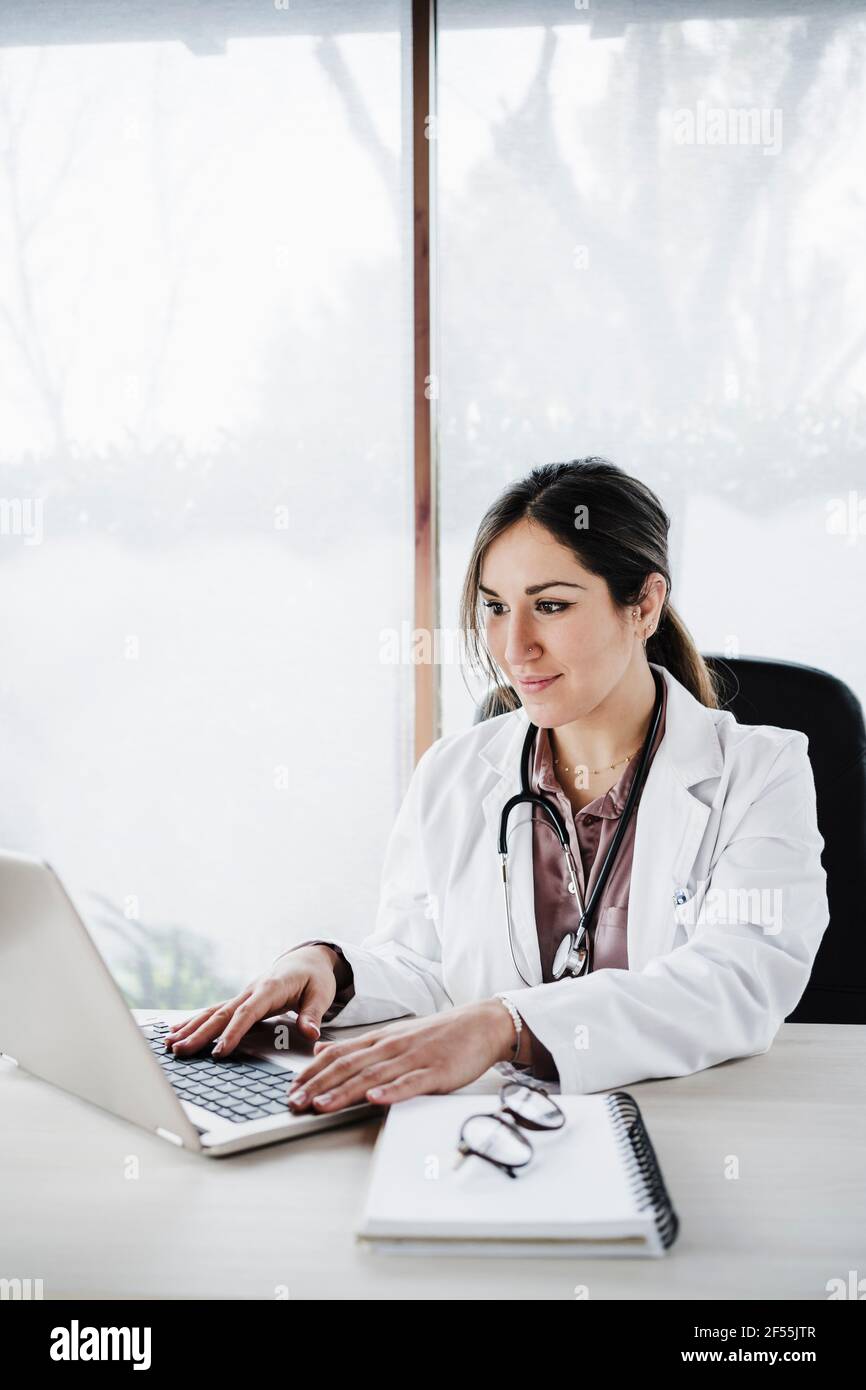 Doctor working on laptop in hi-res stock photography and images - Alamy